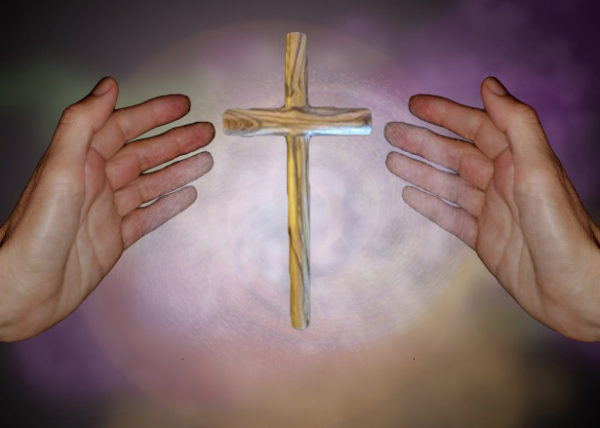 hands offering cross of Jesus - Signs Of The Last Days